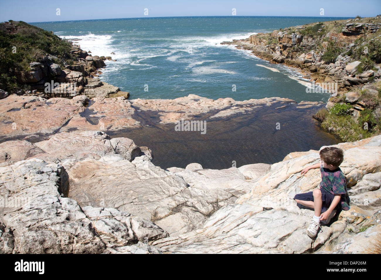 Timothy Larsen (7) looks down on series waterfalls dropping into sea on ...