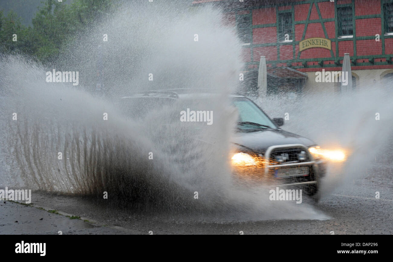 A car drives through a giant puddle of water near Radeberg, Germany, 20 ...