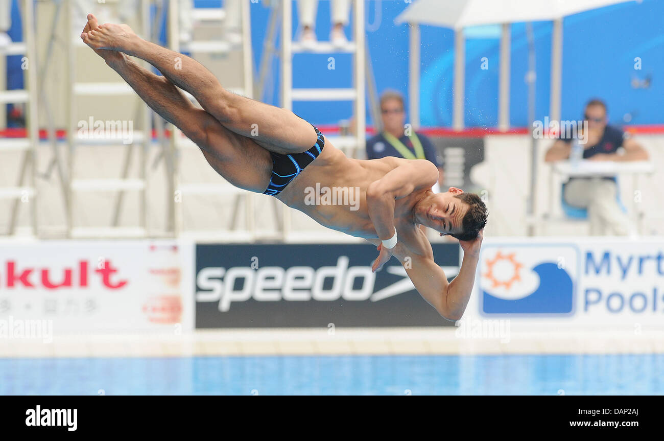 Germany's Stephan Feck dives during the men's 3m springboard ...