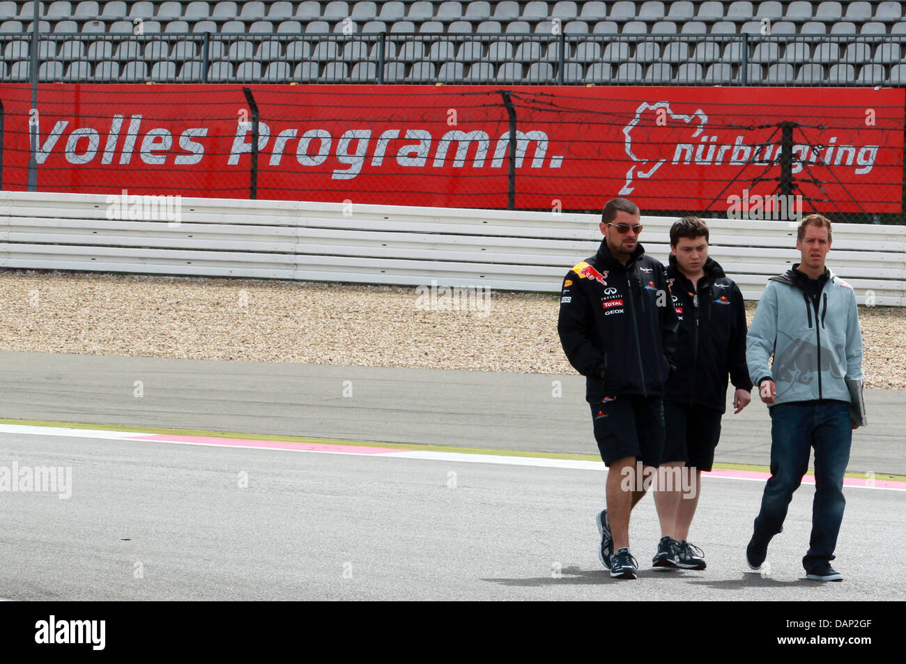 German Formula One driver Sebastian Vettel (R) of Red Bull walks on the ...