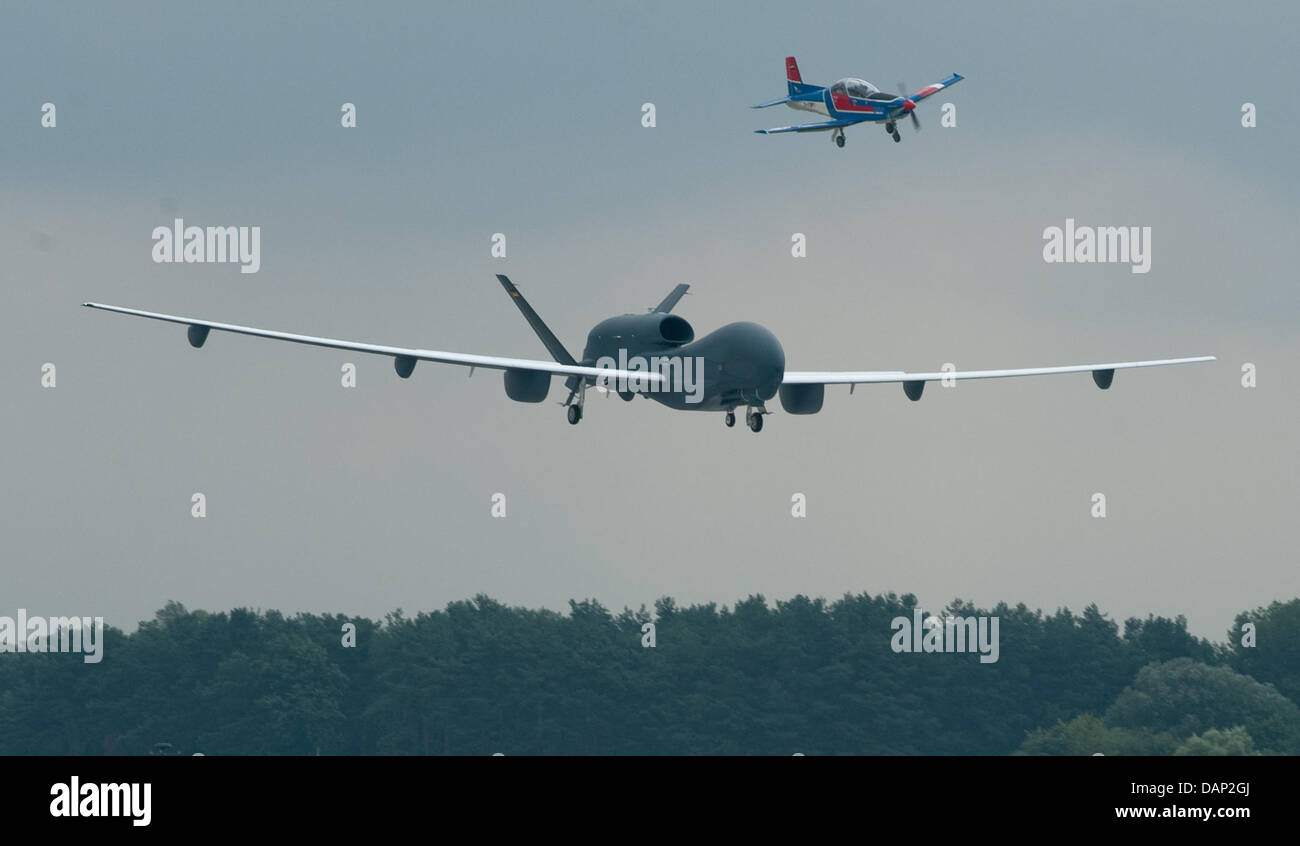 The unmanned aerial vehicle Euro Hawk (L) flies next to an escort plane ...
