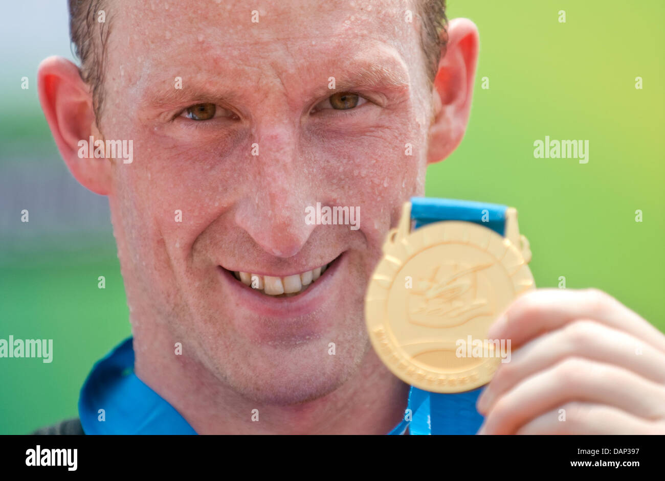 Thomas Lurz from Germany shows his gold medal for the 5km open water ...