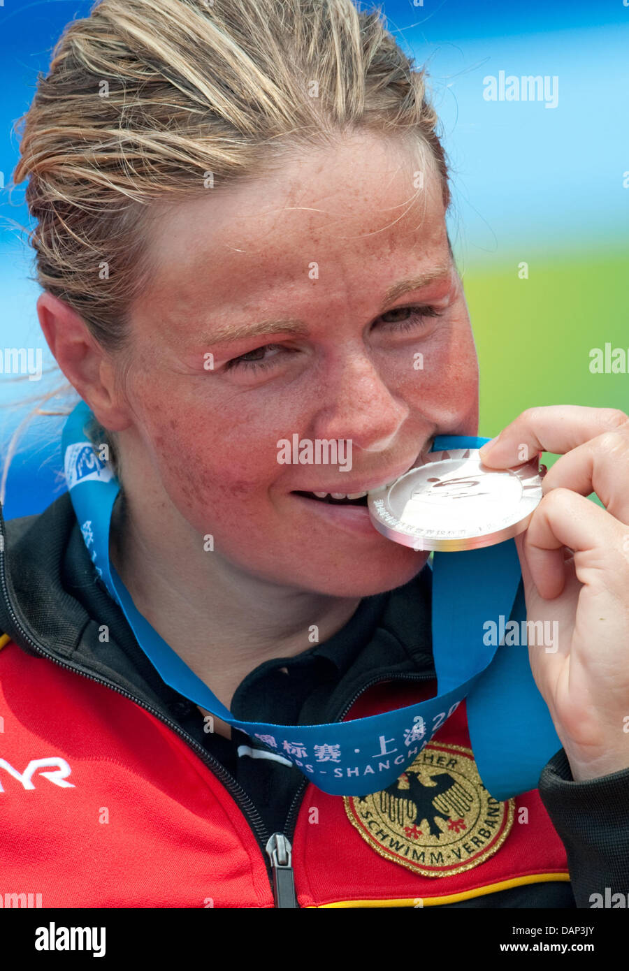 Angela Maurer from Germany bites her silver medal after the women's 25 ...