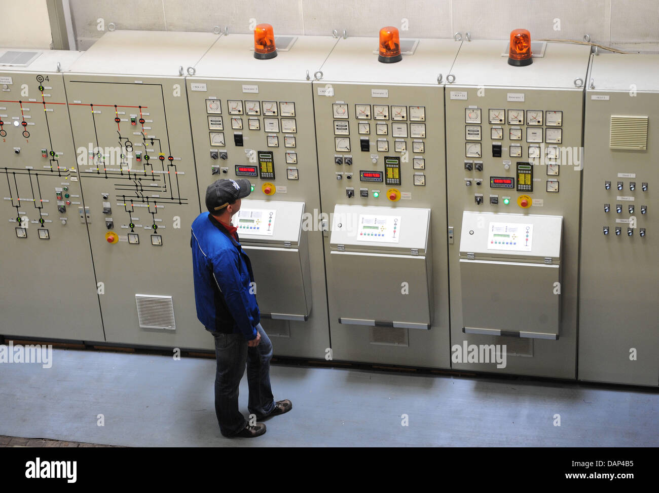 Technician stands in front of an switchboard of diesel emergency ...