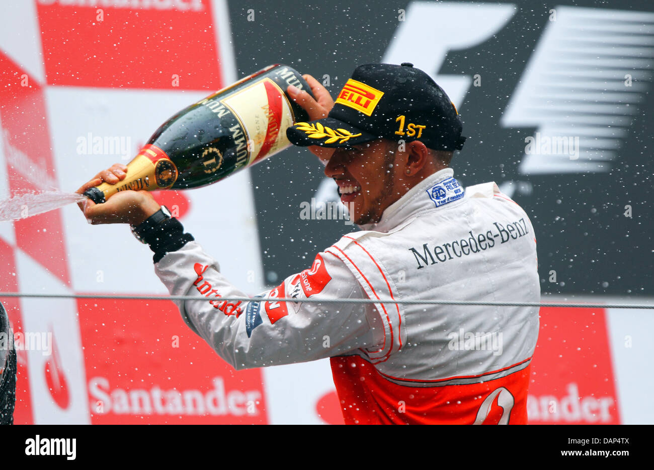 McLaren Mercedes' British driver Lewis Hamilton celebrates winning on ...