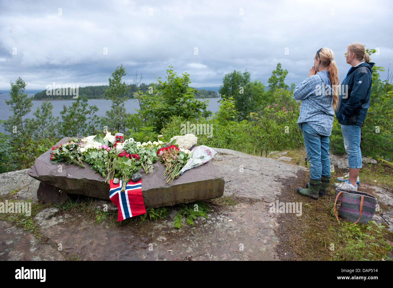 Girls stand near a makeshift memorial for the victims of the massacre ...