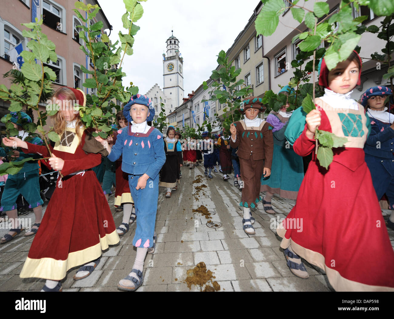 Girls and boys walk through the city centre of Ravensburg dressed in ...