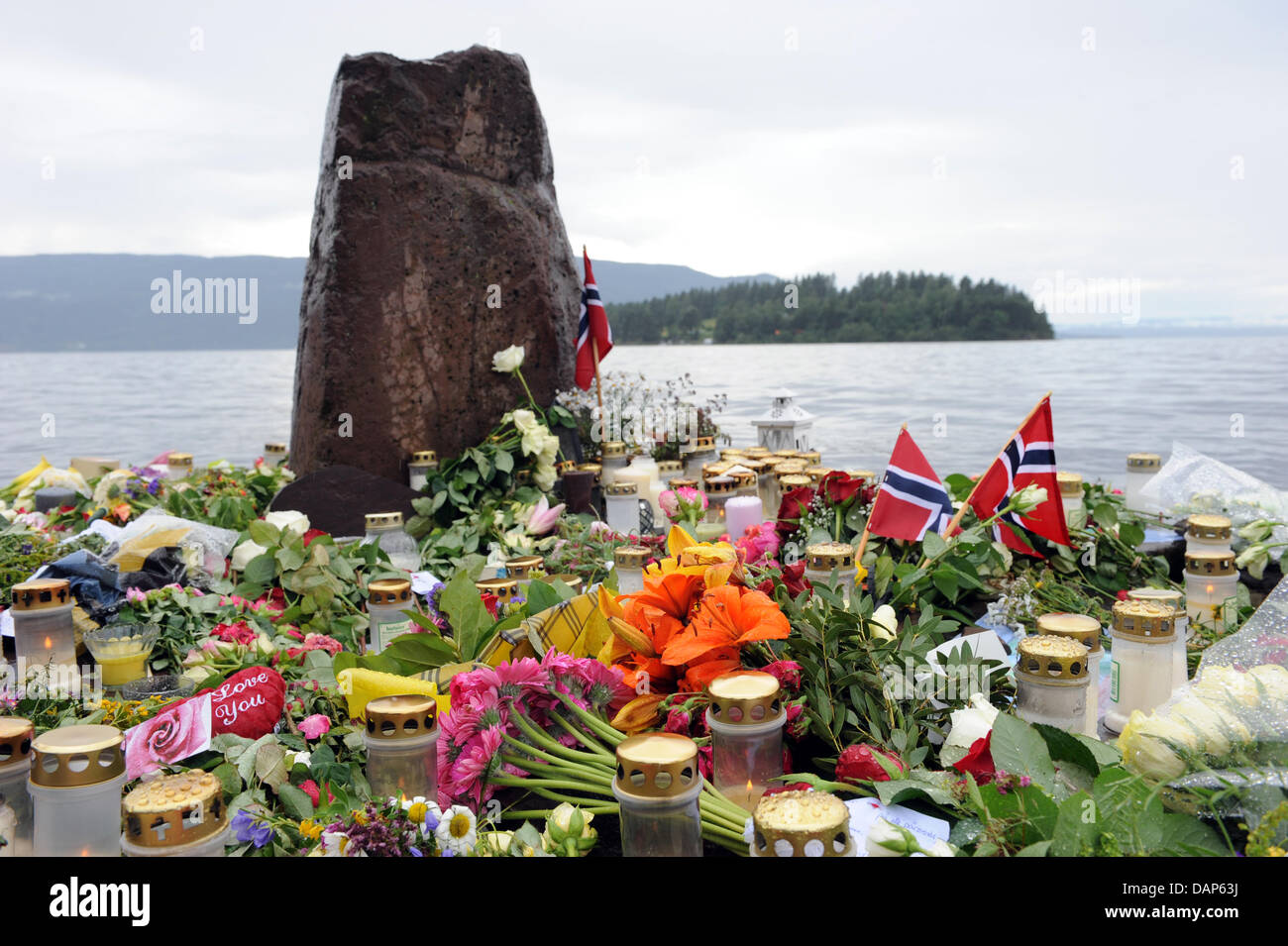 Candles and flowers are laying opposite of Utoya Island, Norway, 26 ...