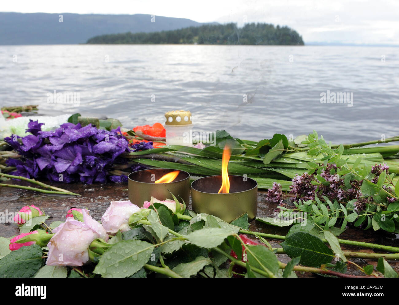 Candles and flowers are laying opposite of Utoya Island, Norway, 26 ...