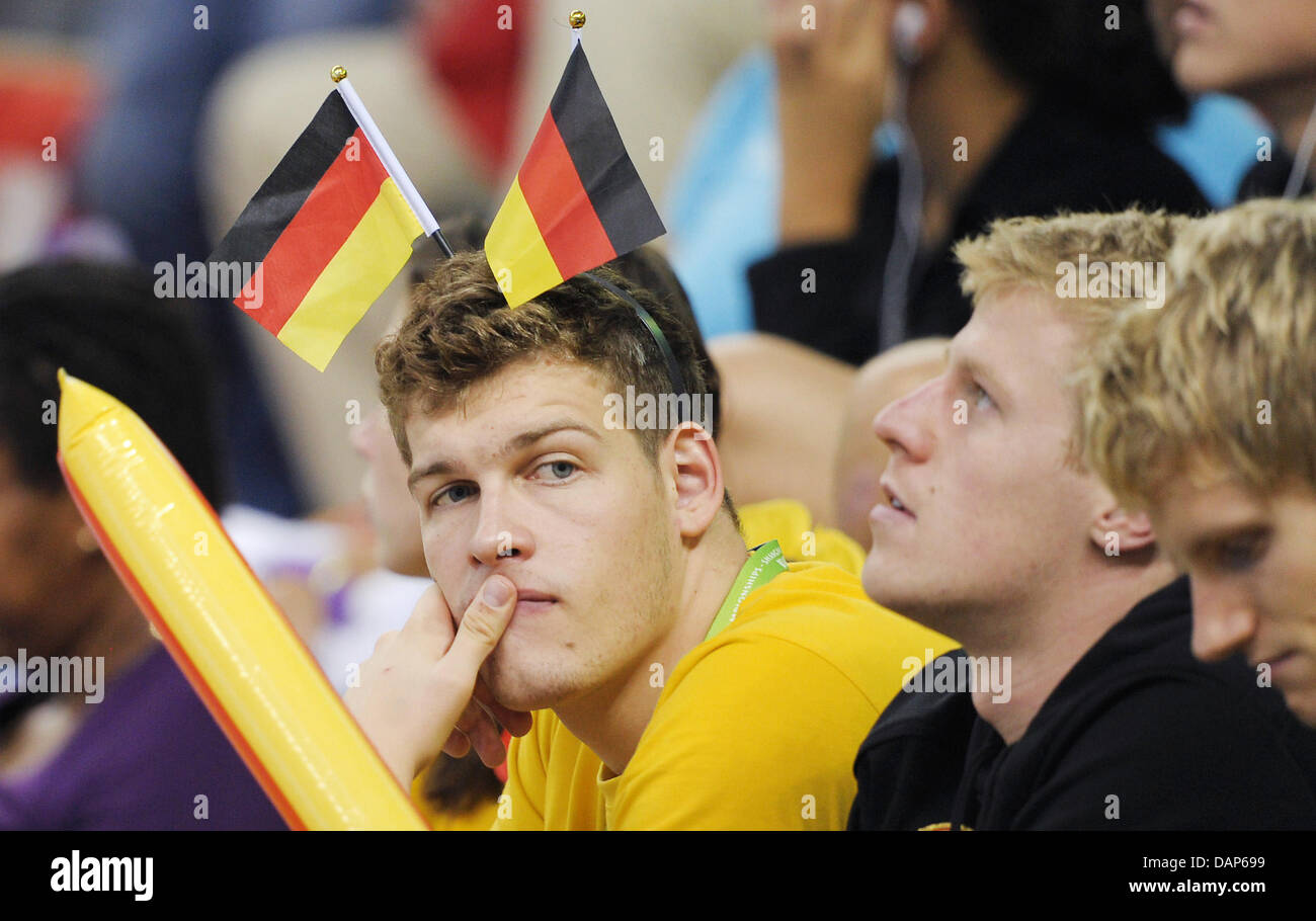 Swimmer Tim Wallburger of Germany (l) follows the finals at the 2011 FINA Swimming World ...