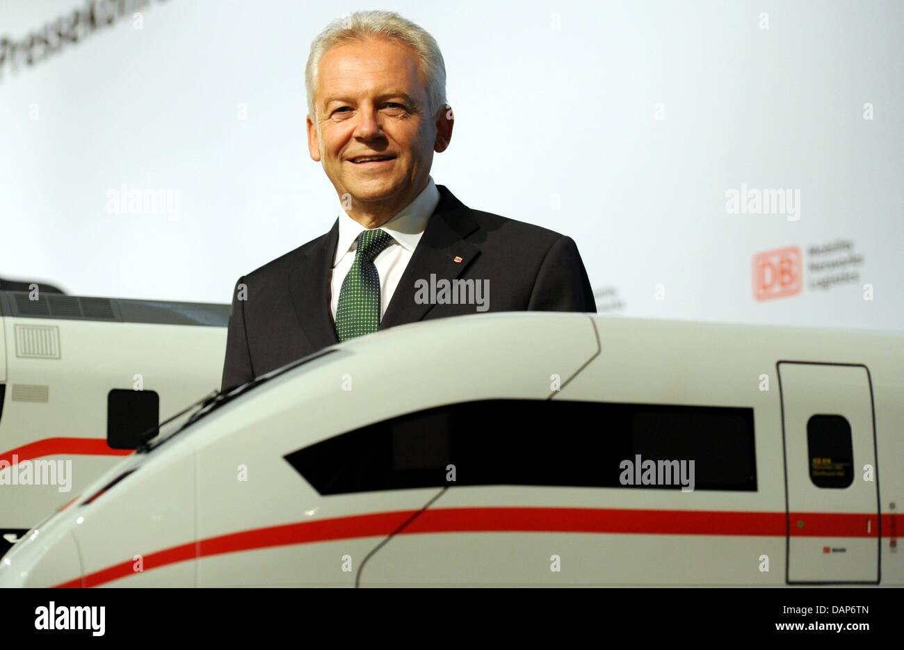 Deutsche Bahn CEO Ruediger Grube poses between miniature trains at the ...