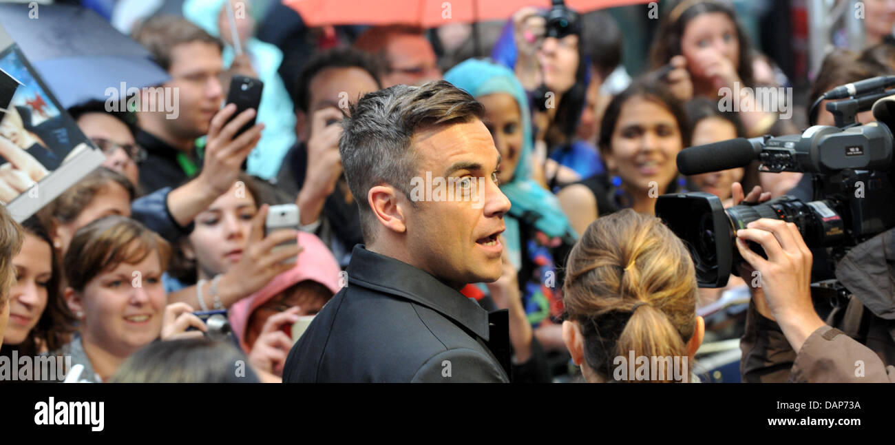 Robbie Williams attends the premiere of the movie 'Cars 2' at the ...
