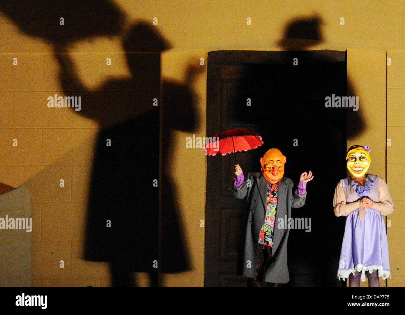 Actors behind huge masks perform as the village poet Mr rat poison (L ...