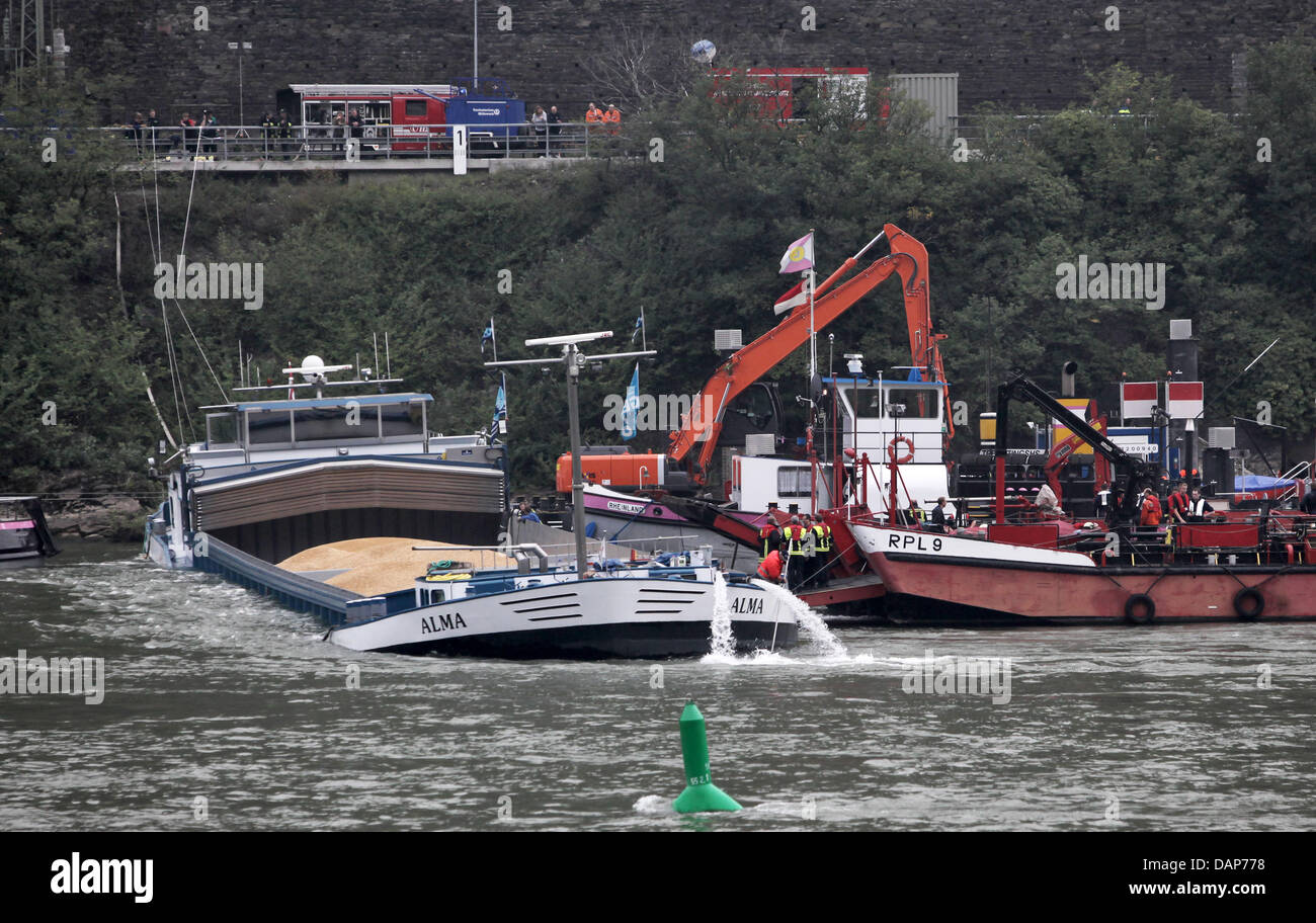 A damaged inland navigation vessel remains inactive in the River Rhine ...