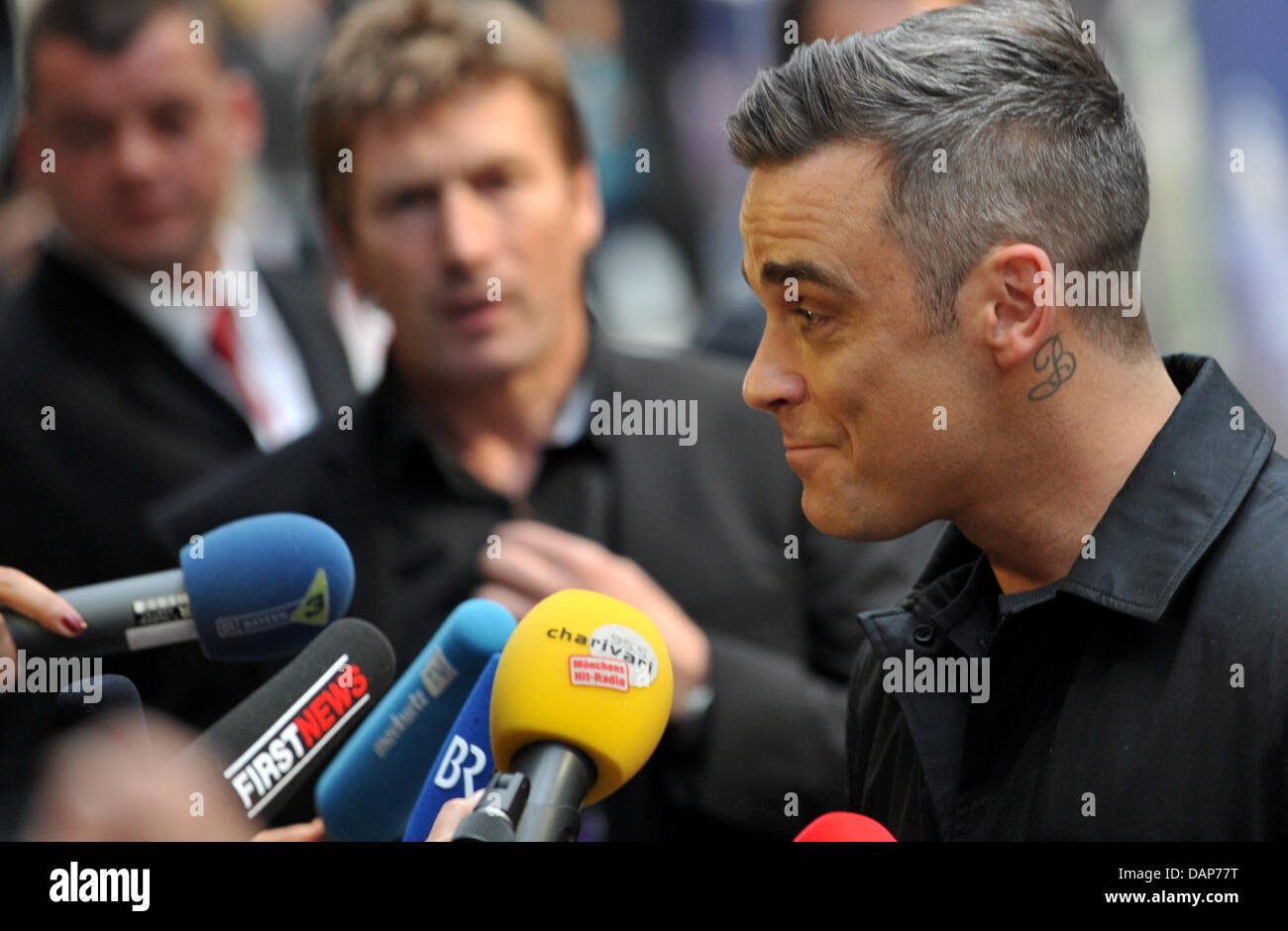Robbie Williams stands in front numerous microphones prior to the ...