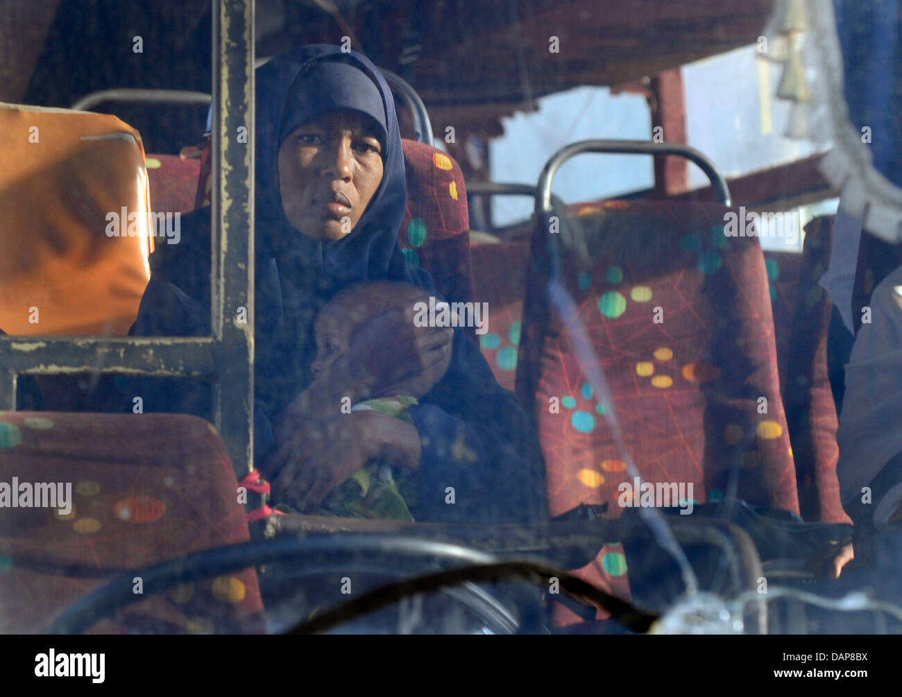 A woman and her child sit in a bus, coming from the Somali boarder, in ...