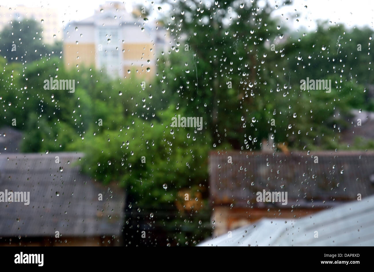 Summer rain drops on window with blurred city view Stock Photo - Alamy