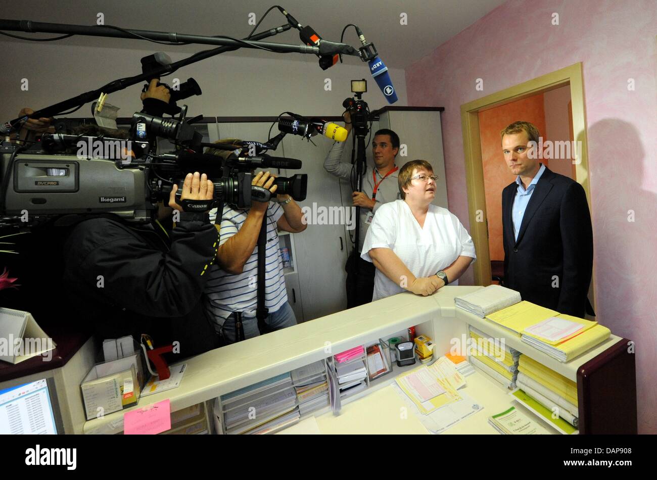 Health minister Daniel Bahr talks to doctor Angela Ruetz at her medical ...