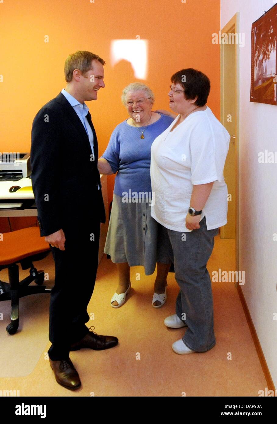Health minister Daniel Bahr talks to doctor Angela Ruetz (R) at her ...