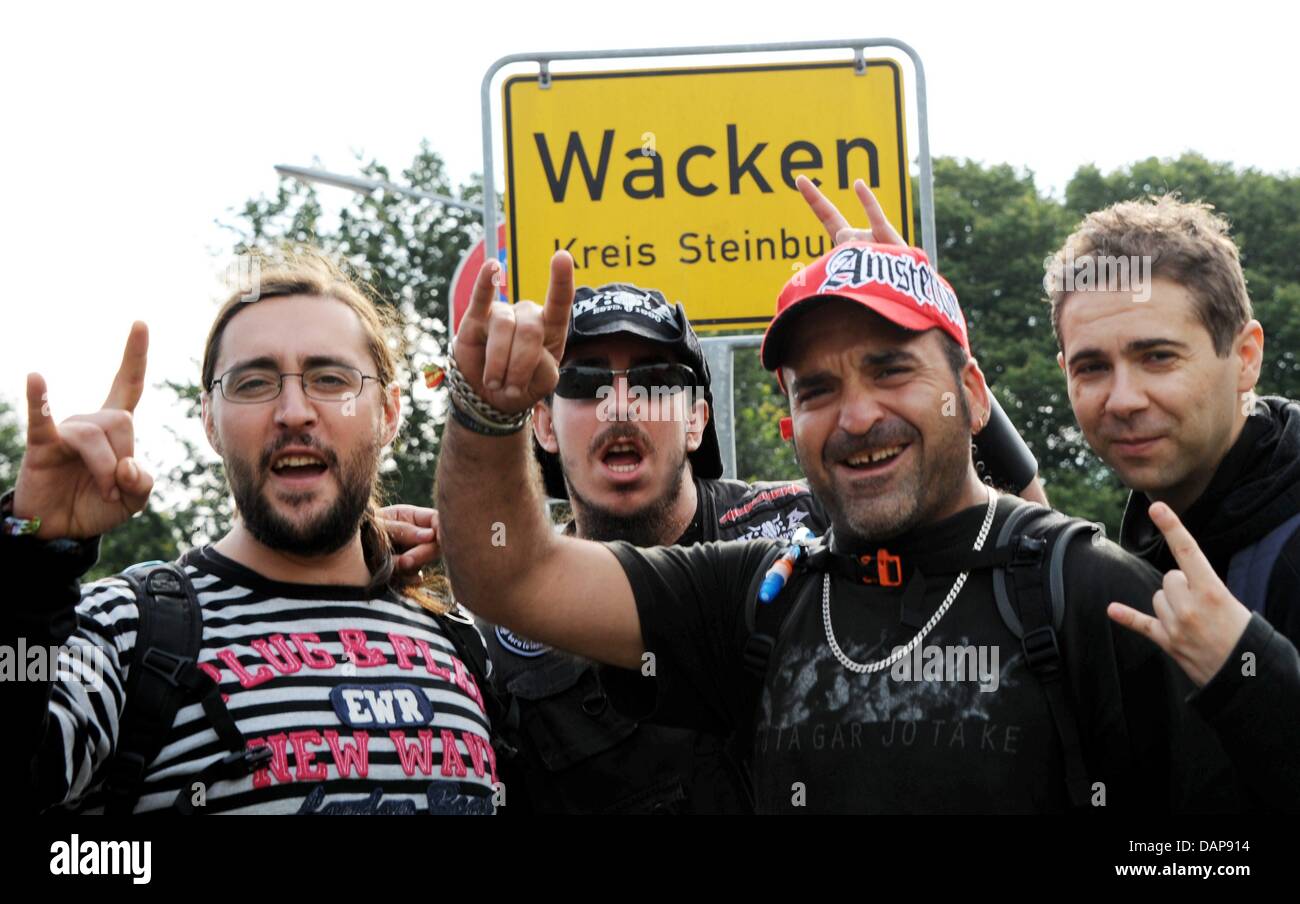 Spanish heavy metal fans stand at the place-name sign in Wacken ...