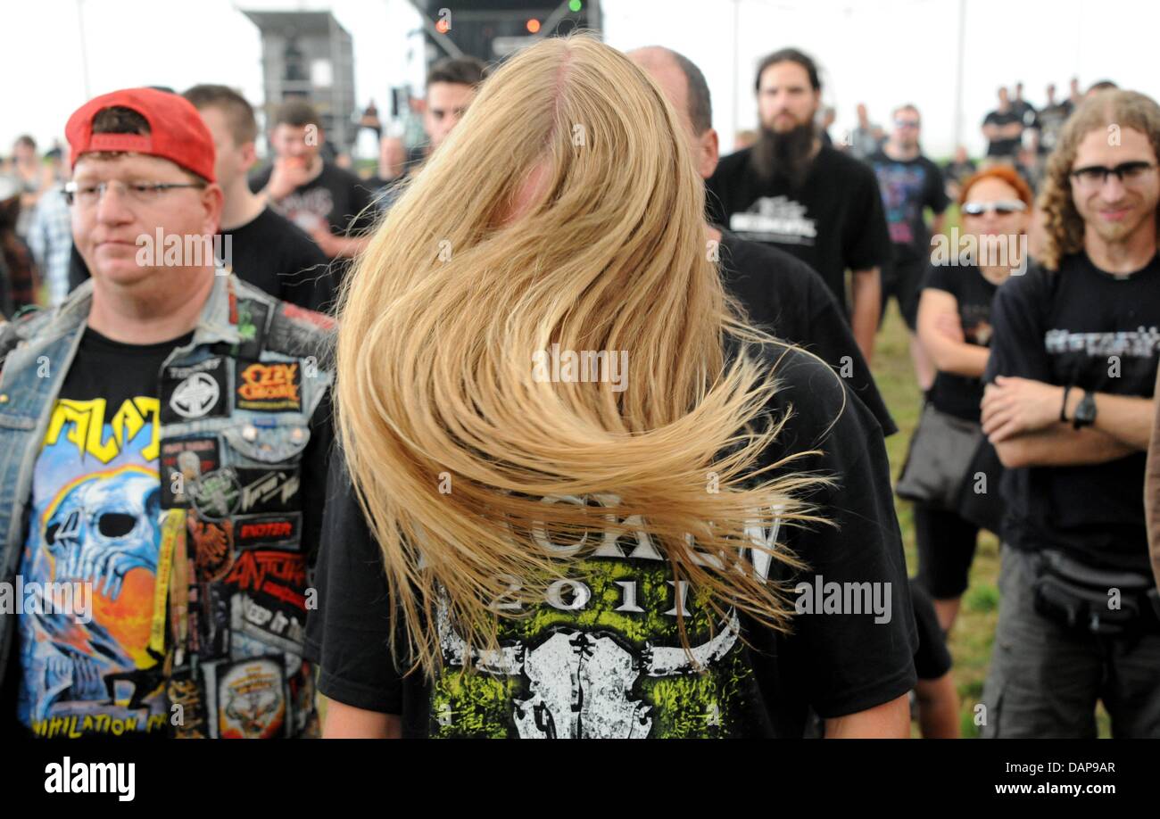 Heavy metal fans are pictured while head banging at the music festival ...