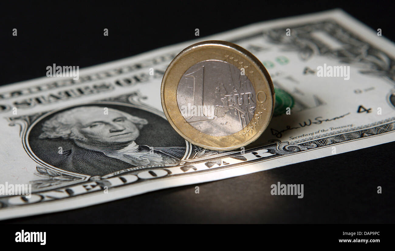 A one Euro coin lies on a one dollar bill in Leipzig, Germany, 8 ...