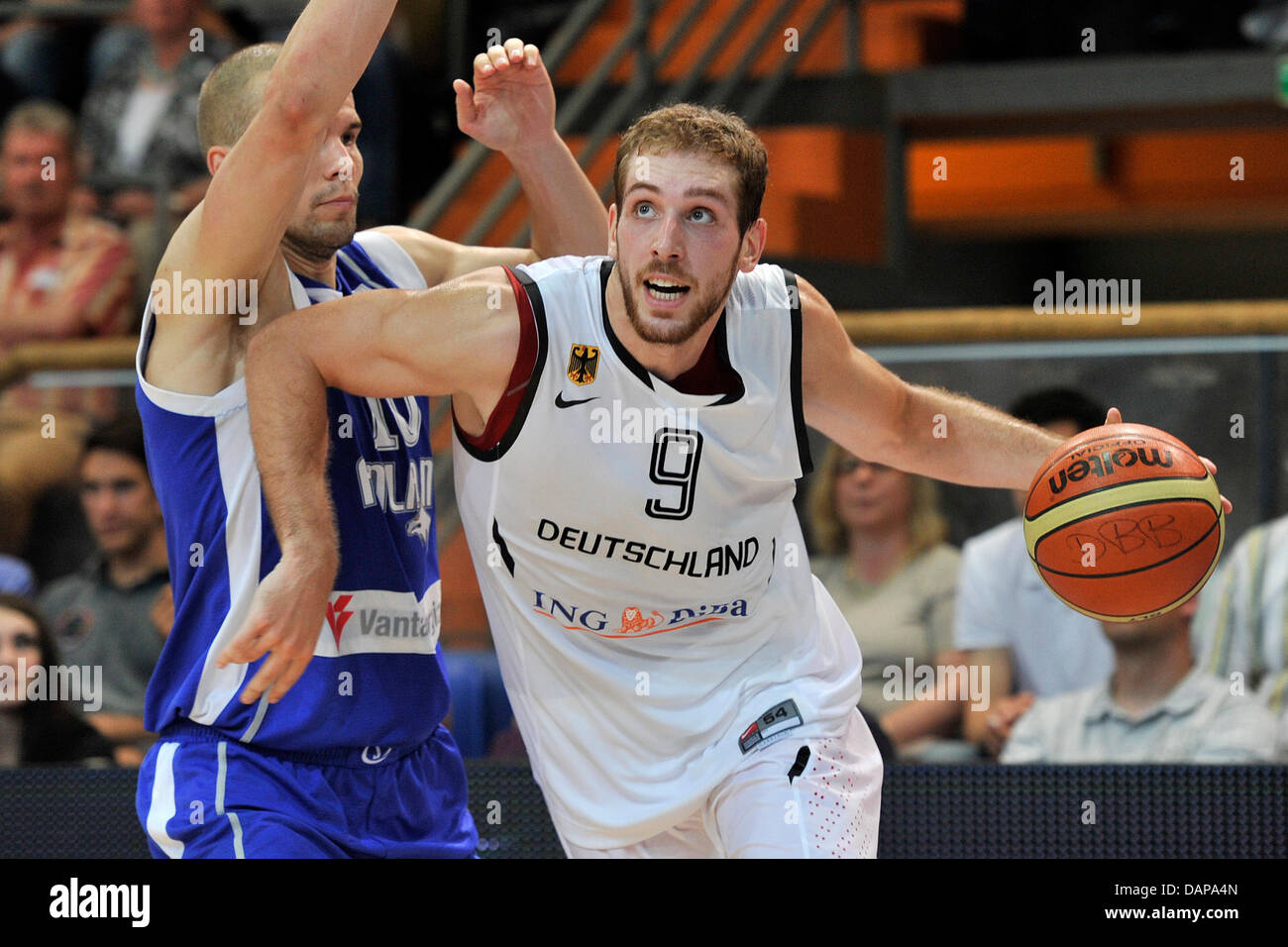 Finland's Tuukka Kotti (L) and Germany's Tim Ohlbrecht vie for the ball during the international ...