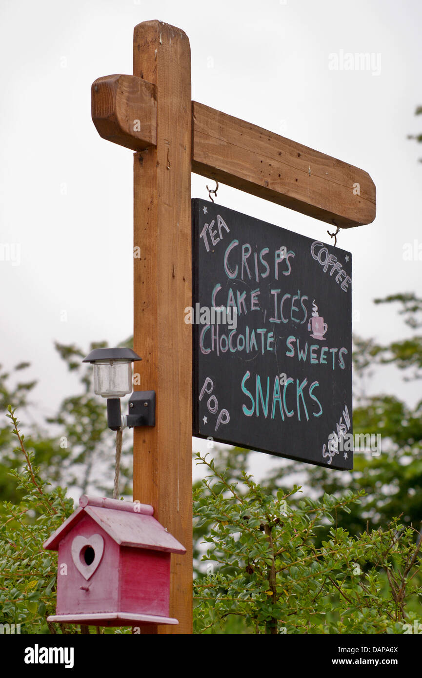 Roadside sign at a teashop advertising cakes, snacks and tea and hot ...