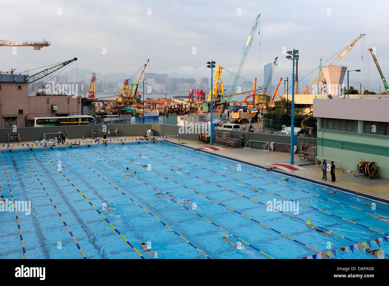 China, Hong Kong, Construction area at Victoria Harbour behind swimming ...