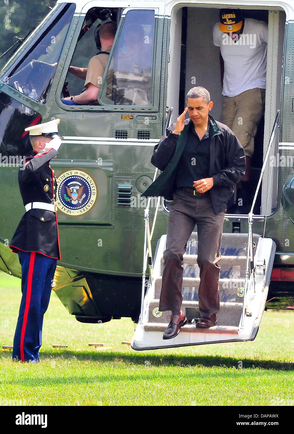 United States President Barack Obama salutes as he and his family ...