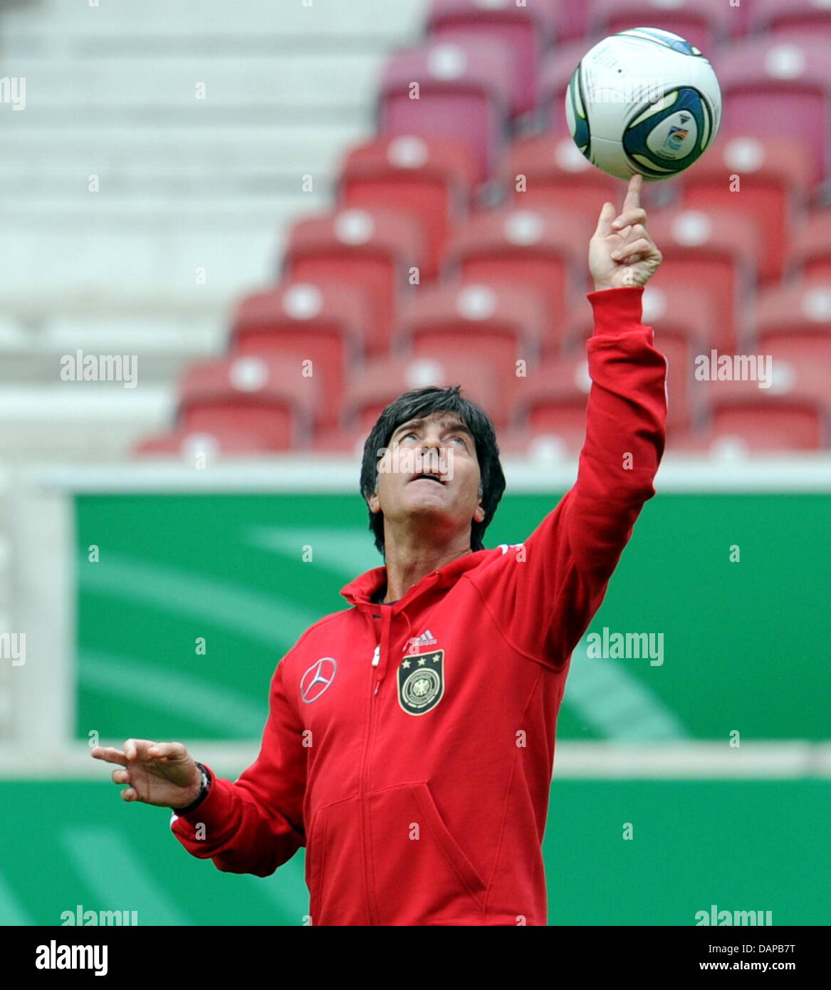 Joachim Loew, coach of the German soccer national team, balances a ball ...