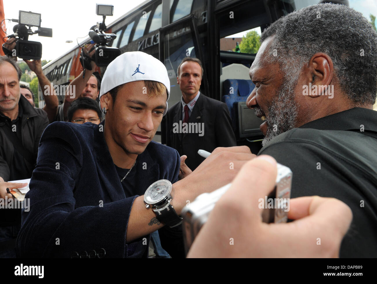 The Brazialian national soccer player Neymar (L) signs autographs ...