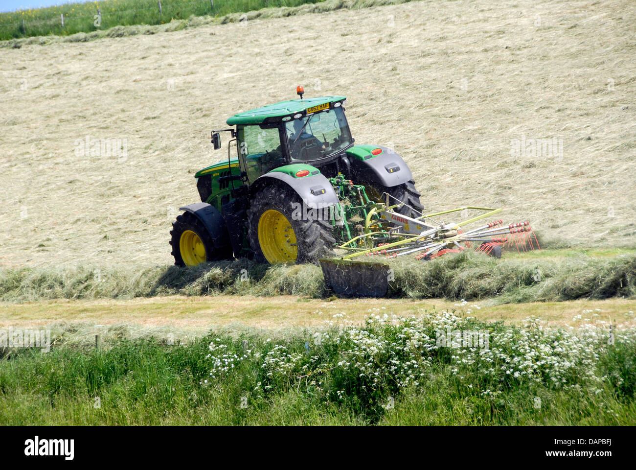 Tractor cutting hay for bales for silage, Sussex, England UK Stock ...