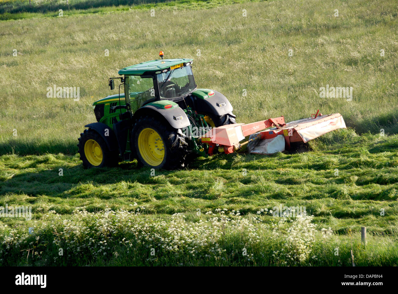 Tractor cutting grass in Sussex farm England UK Stock Photo - Alamy