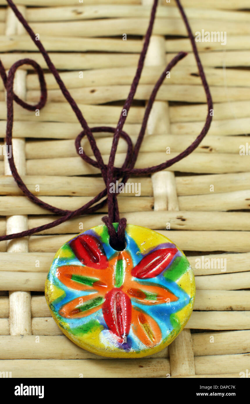 clay handmade amulet red blue and yellow Stock Photo - Alamy