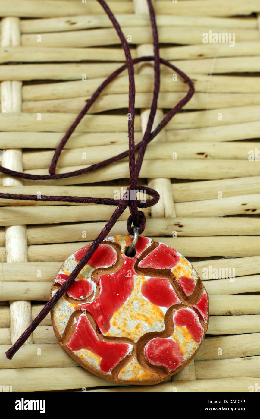 clay handmade amulet red and yellow Stock Photo - Alamy