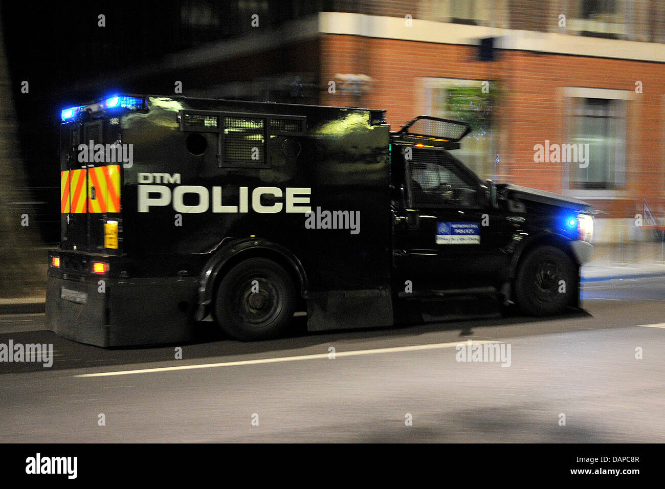 An armored police car drives through a street in Westminster, London ...