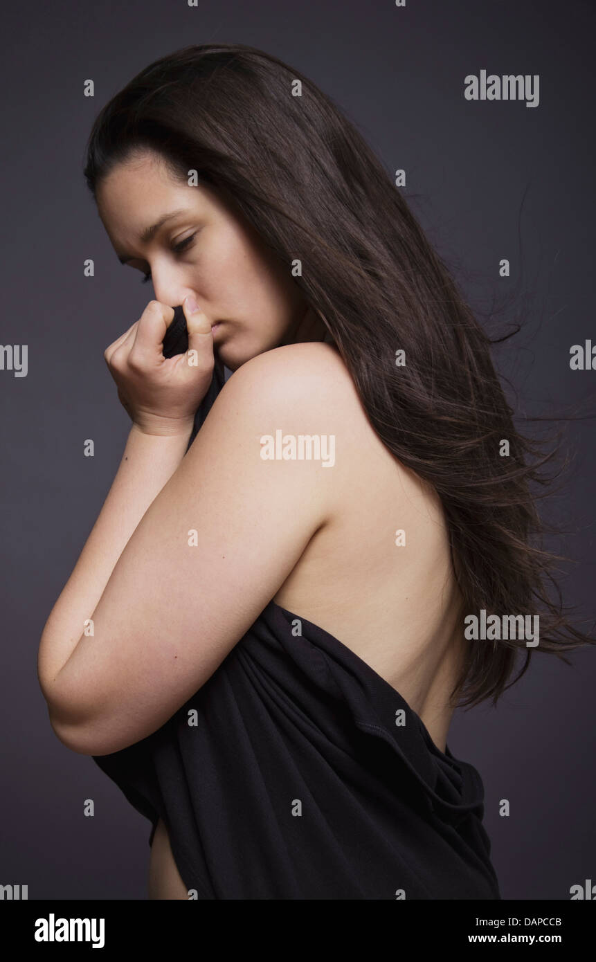 Young woman covering with clothes, close up Stock Photo - Alamy