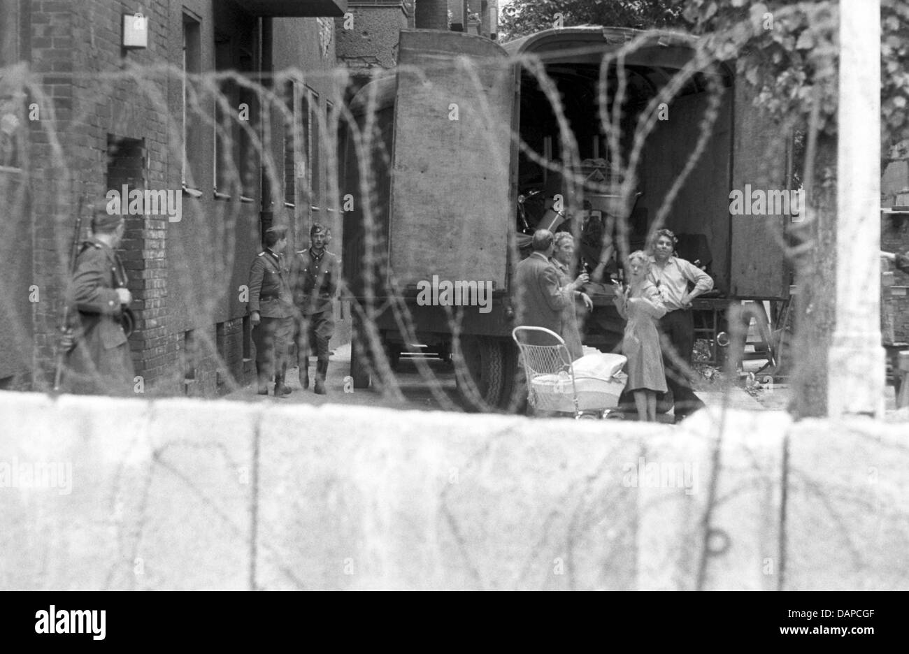 FILE - An archive picture dated 1961 shows a family behind barbed wire ...