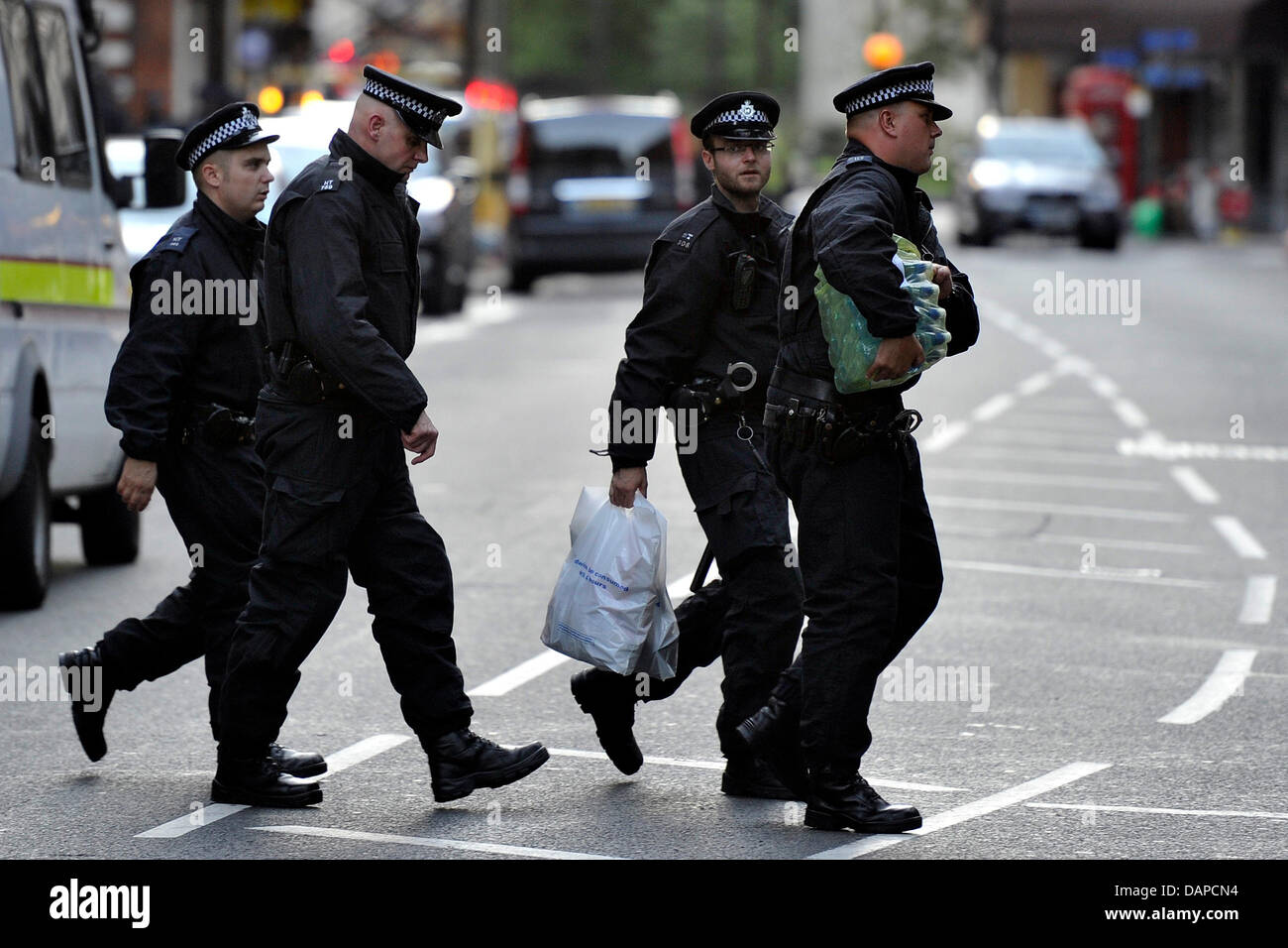 Police officers prepare for the upcoming night in Westminster, London ...