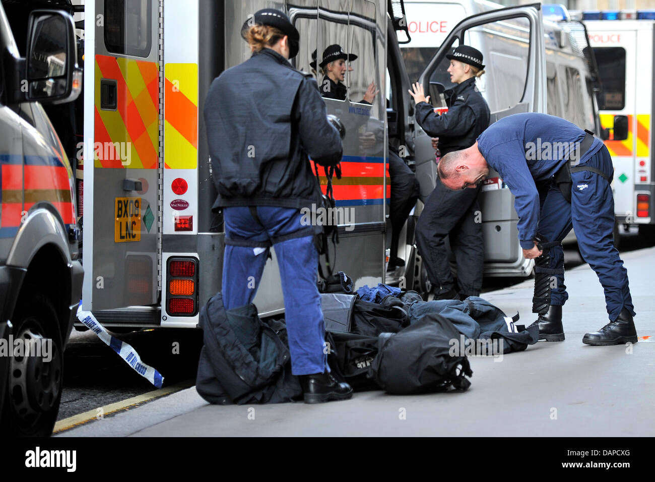 Police officers put on riot gear for the upcoming night in Westminster ...