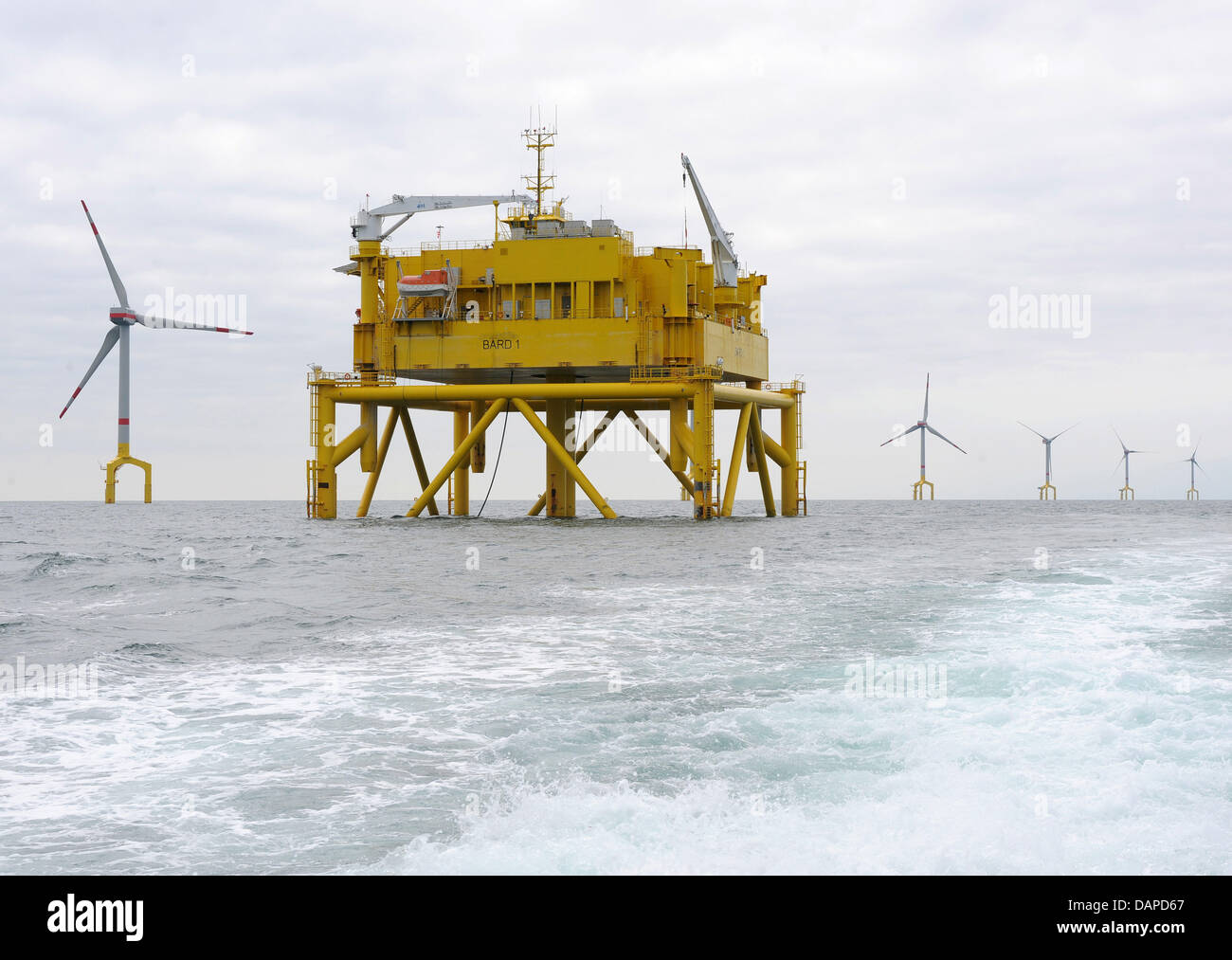 The wash of a tender boat moves in the North Sea through the wind farm ...