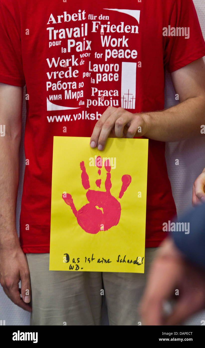 A red handprint is held as these handprints by the group 'Red Hand' are ...