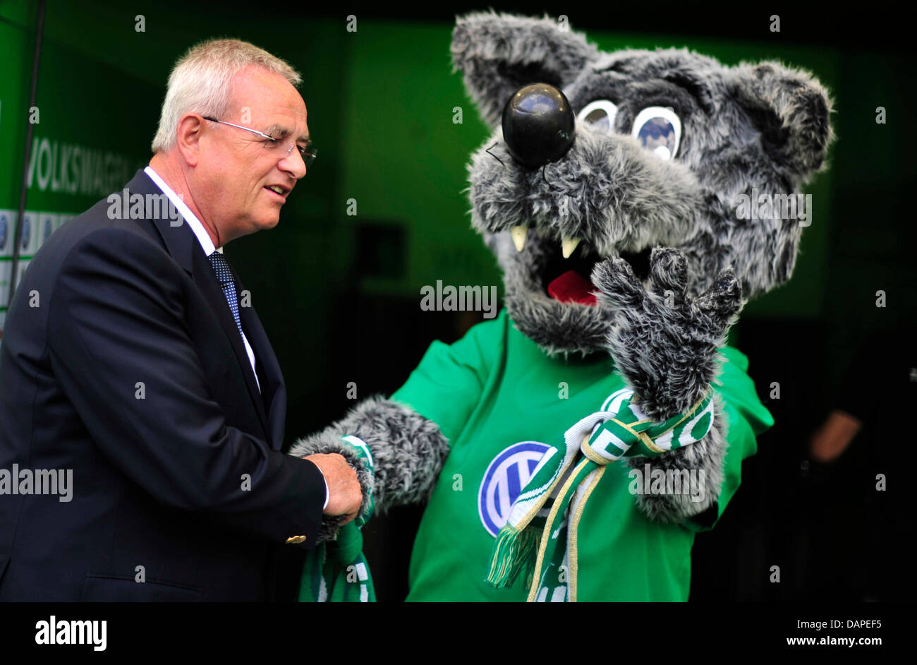 CEO of Volkswagen AG, Martin Winterkorn, jokes with mascot 'Wolfi ...