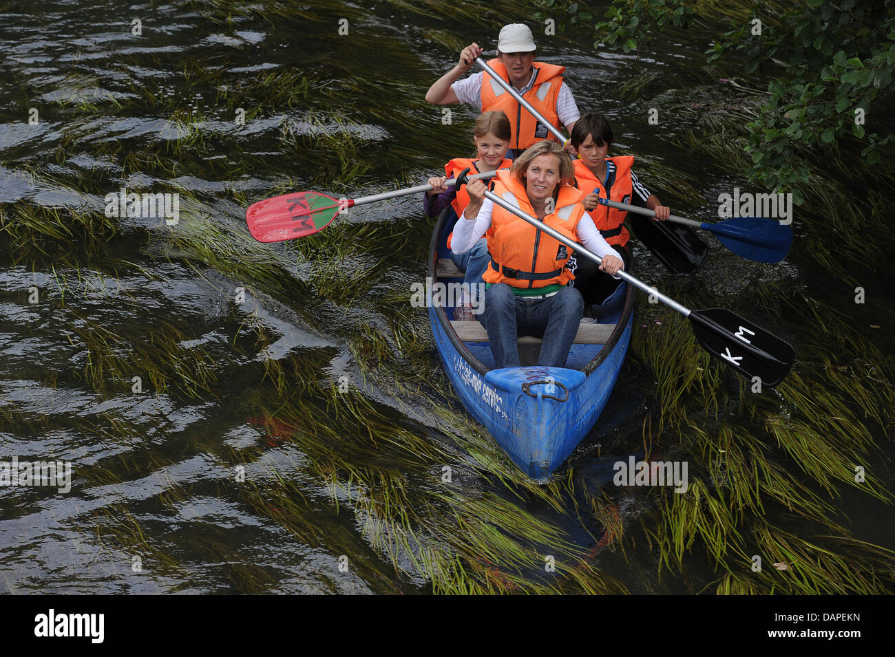 Two young canoers cheer as they paddle through the wild currents of the ...