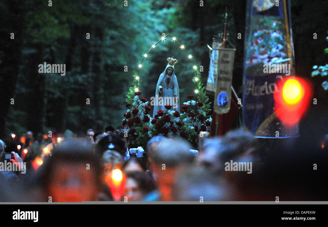 Believers celebrate Assumption Day with a candlelit procession in ...
