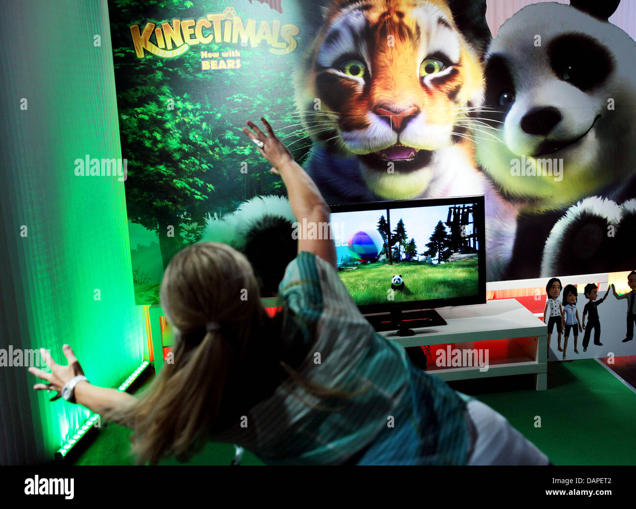 A woman plays a movement-controlled game during a presentation ...