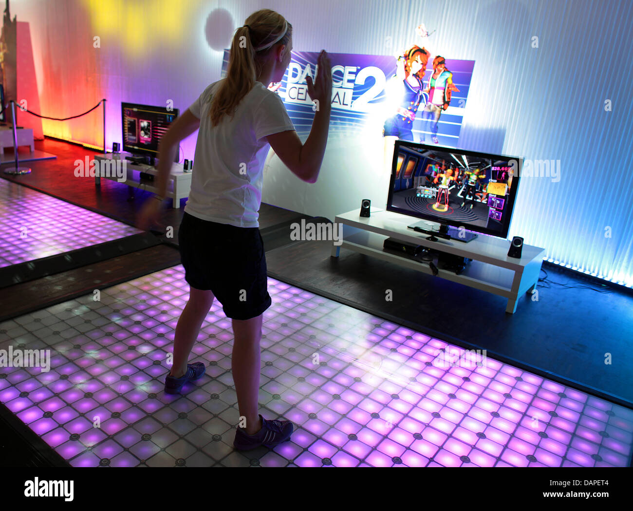 A woman plays a movement-controlled game during a presentation ...