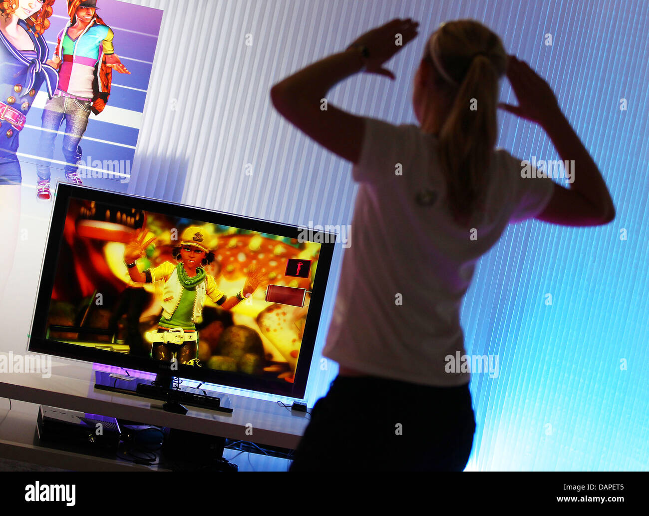 A woman plays a movement-controlled game during a presentation ...