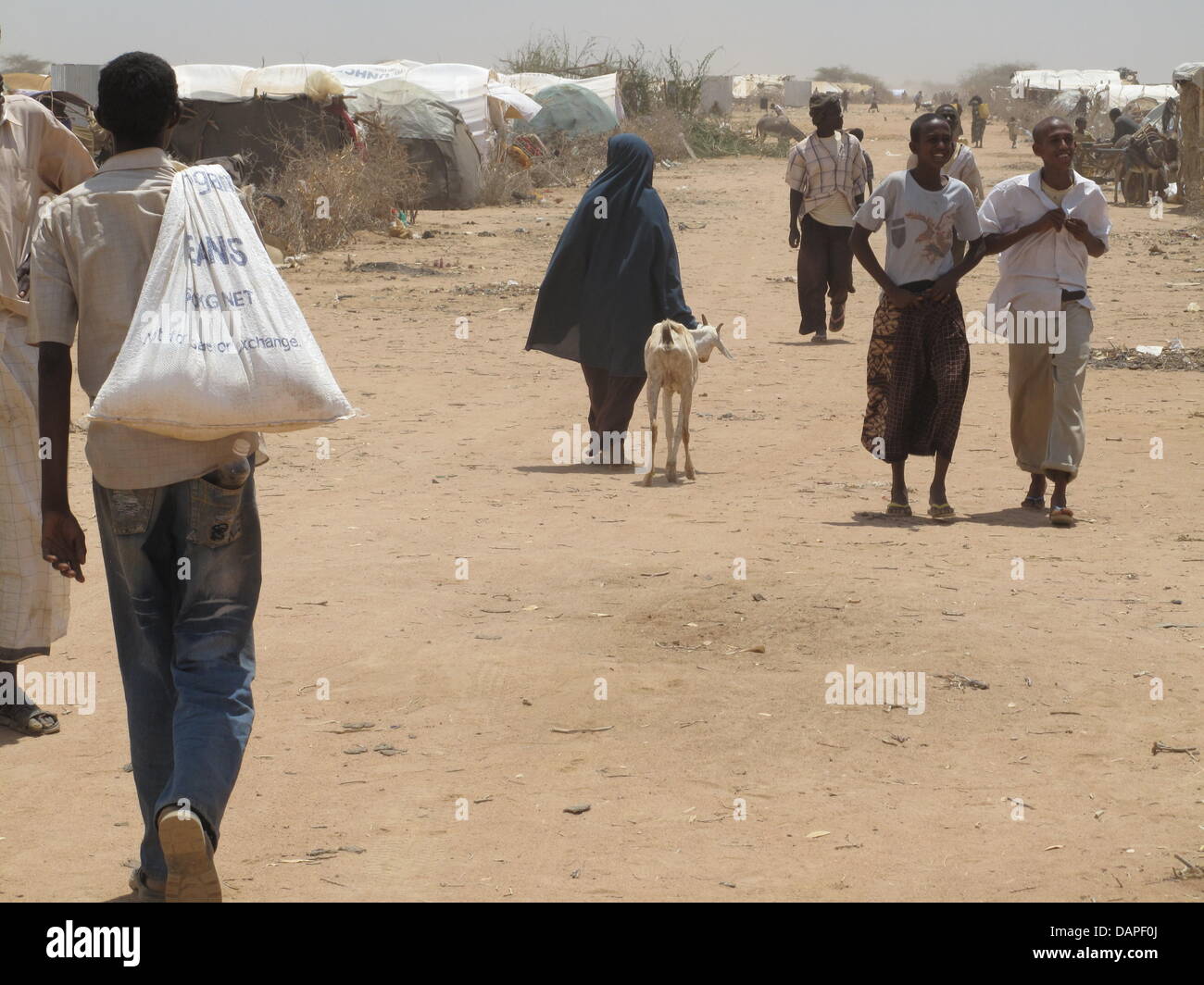 Refugees walk through the Somalian refugee camp Ifo during the visit of ...